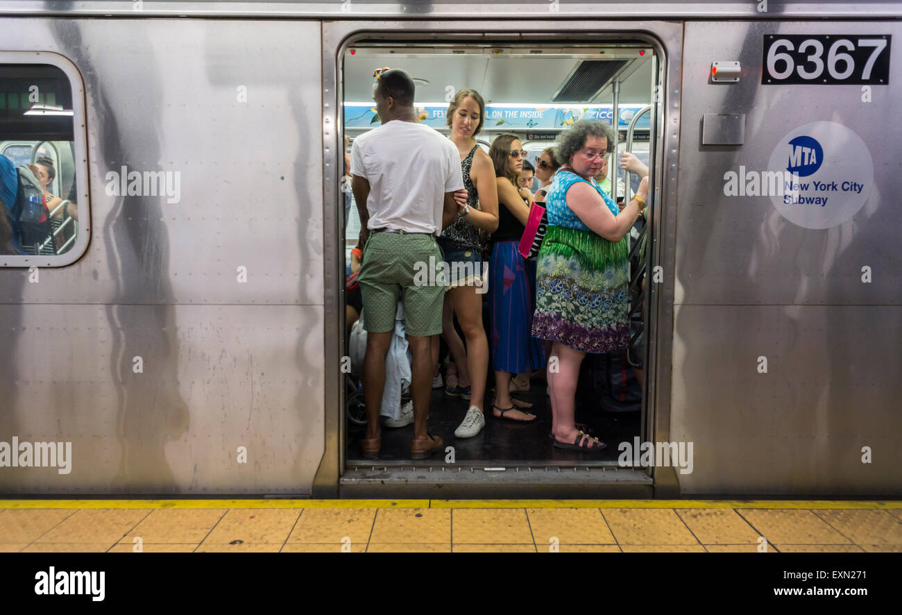 Passengers crowd into a subway train in New York on Sunday, July 12 ...