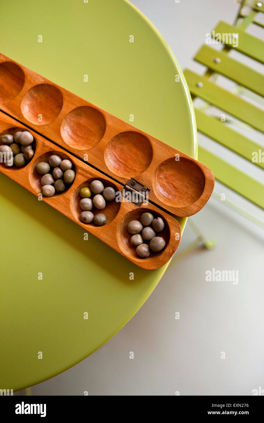 African game Awale on a green table Stock Photo - Alamy