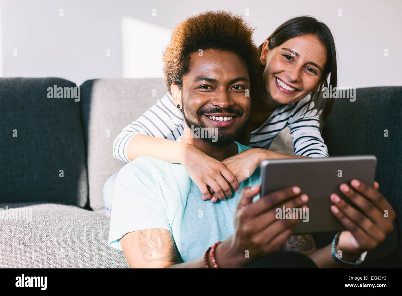 Young couple using digital tablet Stock Photo - Alamy