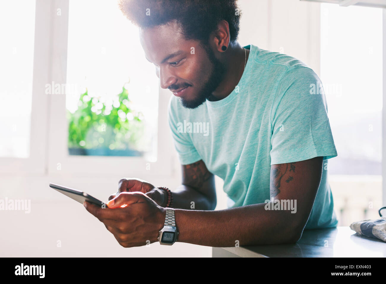 Young man using his phablet at home Stock Photo - Alamy