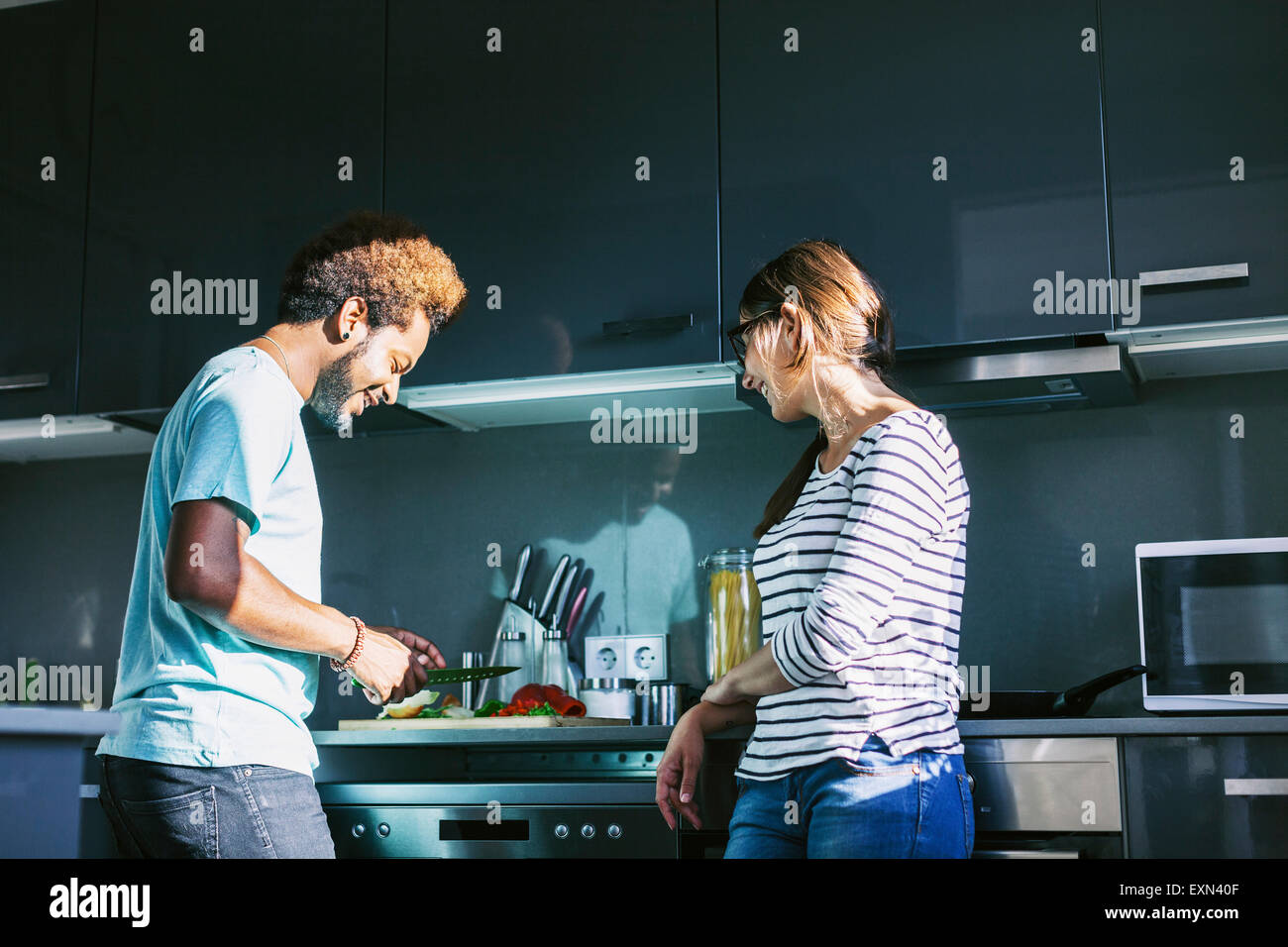Young man preparing food woman hi-res stock photography and images - Alamy