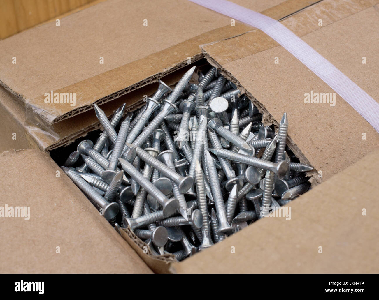 Carpentry nails in brown open cardboard box Stock Photo - Alamy