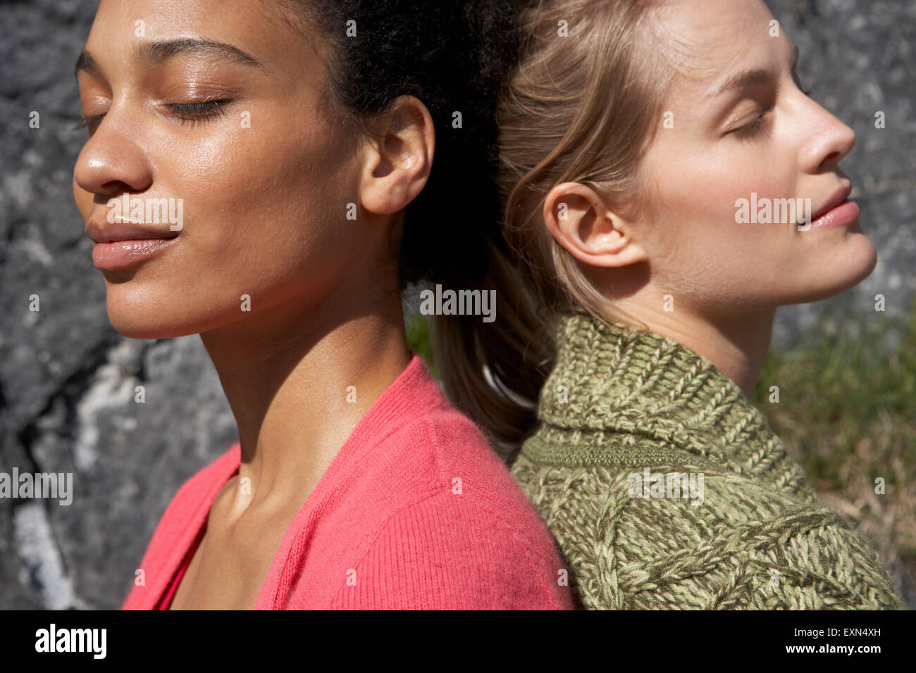 Two sunbathing women, close-up Stock Photo - Alamy