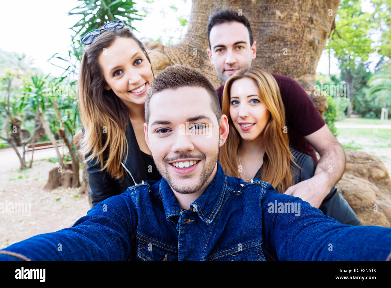 Four friends taking a selfie in a park Stock Photo - Alamy