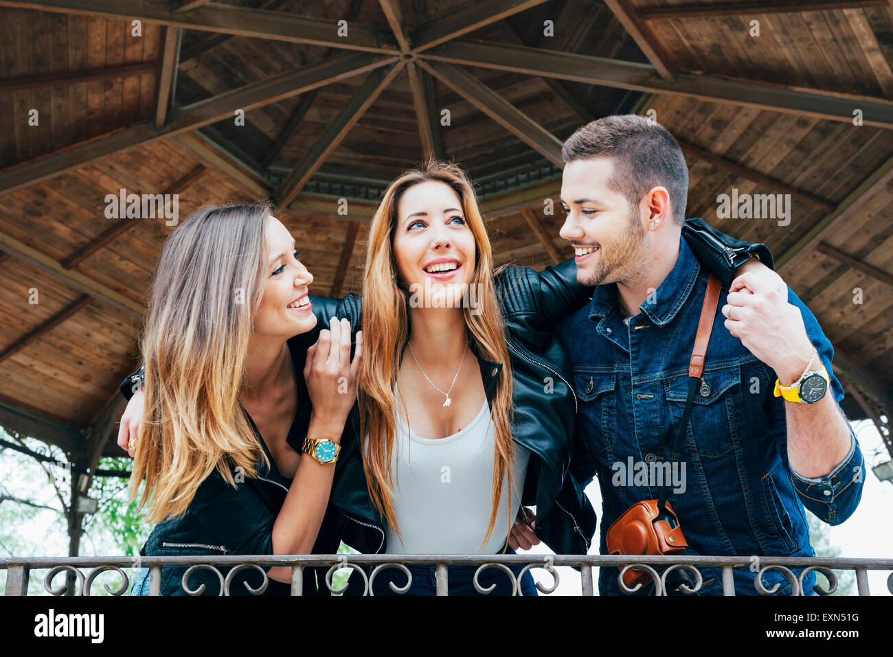 Three friends embracing Stock Photo - Alamy