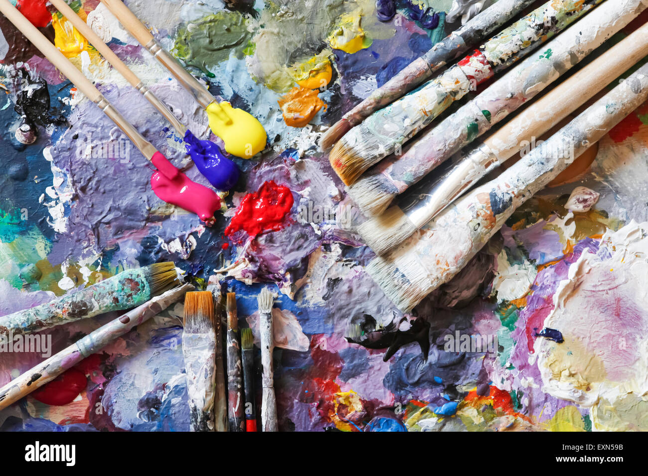 Paintbrushes and fresh paint on artist's palette Stock Photo - Alamy
