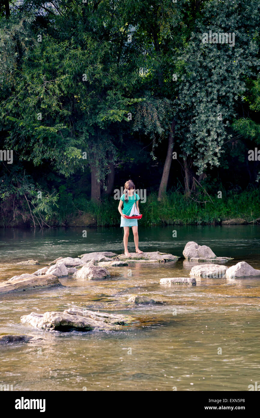 Girl playing with a toy boat hi-res stock photography and images - Alamy