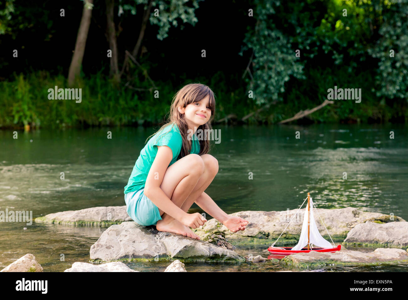 Girl crouching barefoot hi-res stock photography and images - Alamy
