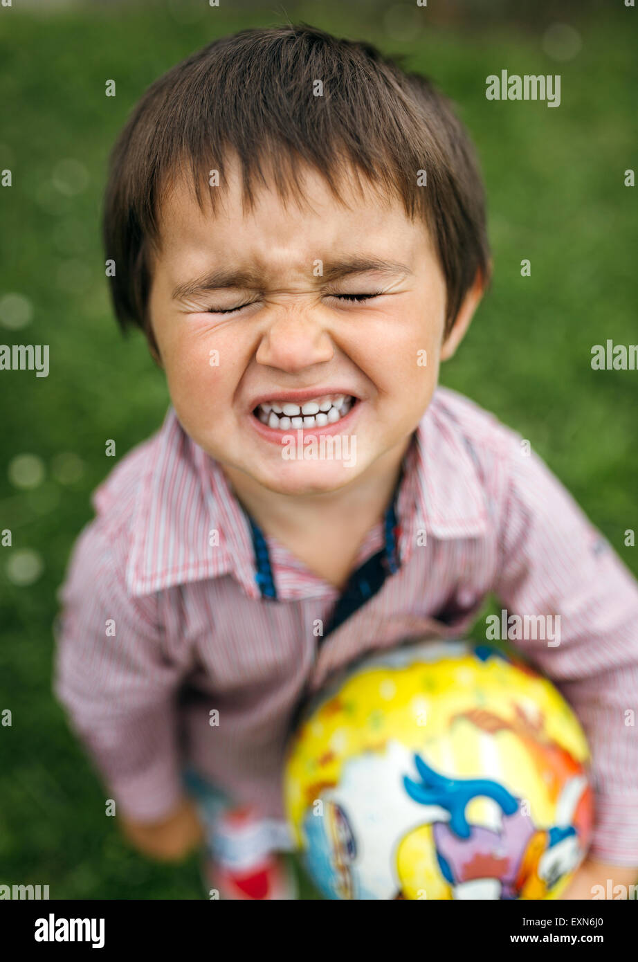 Angry little boy with closed eyes Stock Photo - Alamy
