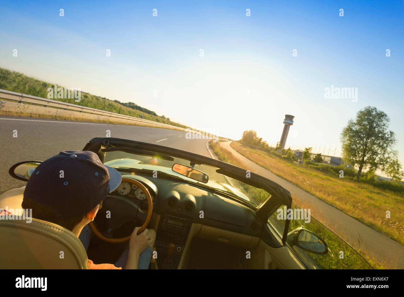 Teenager driving on a country road in a convertible car Stock Photo - Alamy