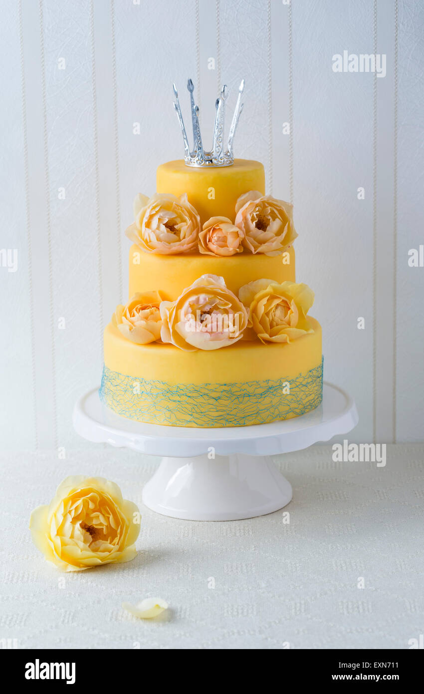Fancy cake coated with fondant decorated with rose blossoms and little ...
