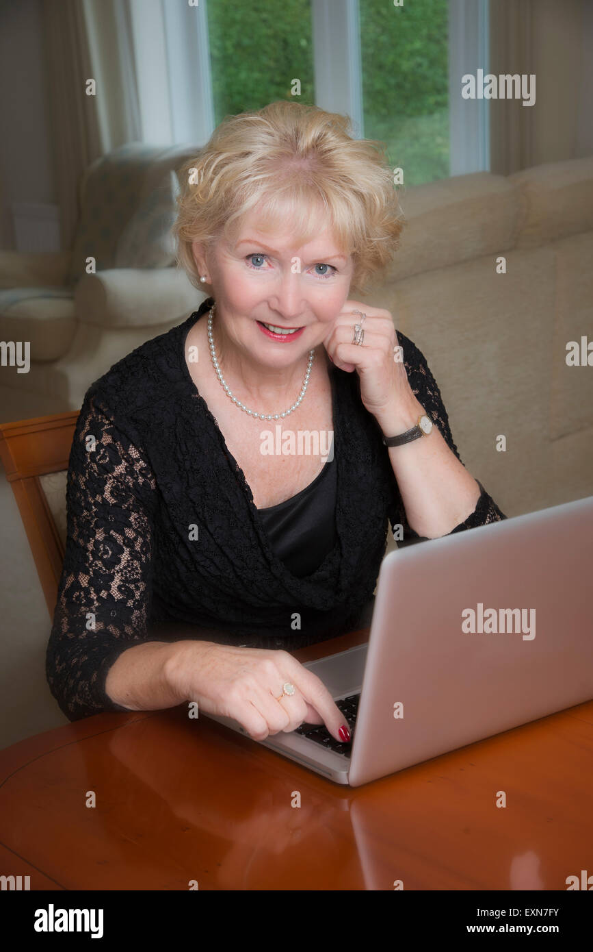Old woman working at computer hi-res stock photography and images - Alamy