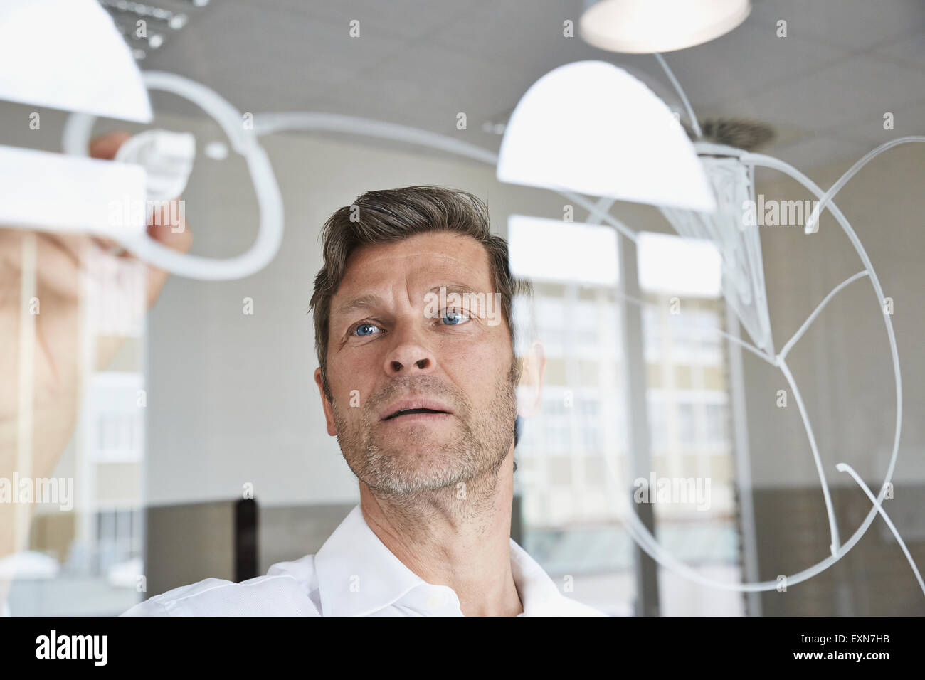 Drawing diagram on glass pane in office hi-res stock photography and ...