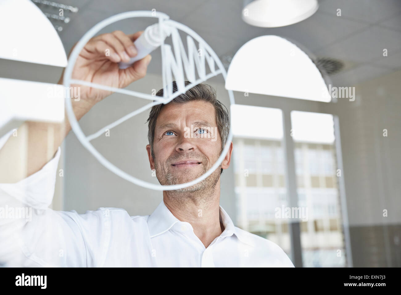 Drawing diagram on glass pane in office hi-res stock photography and ...