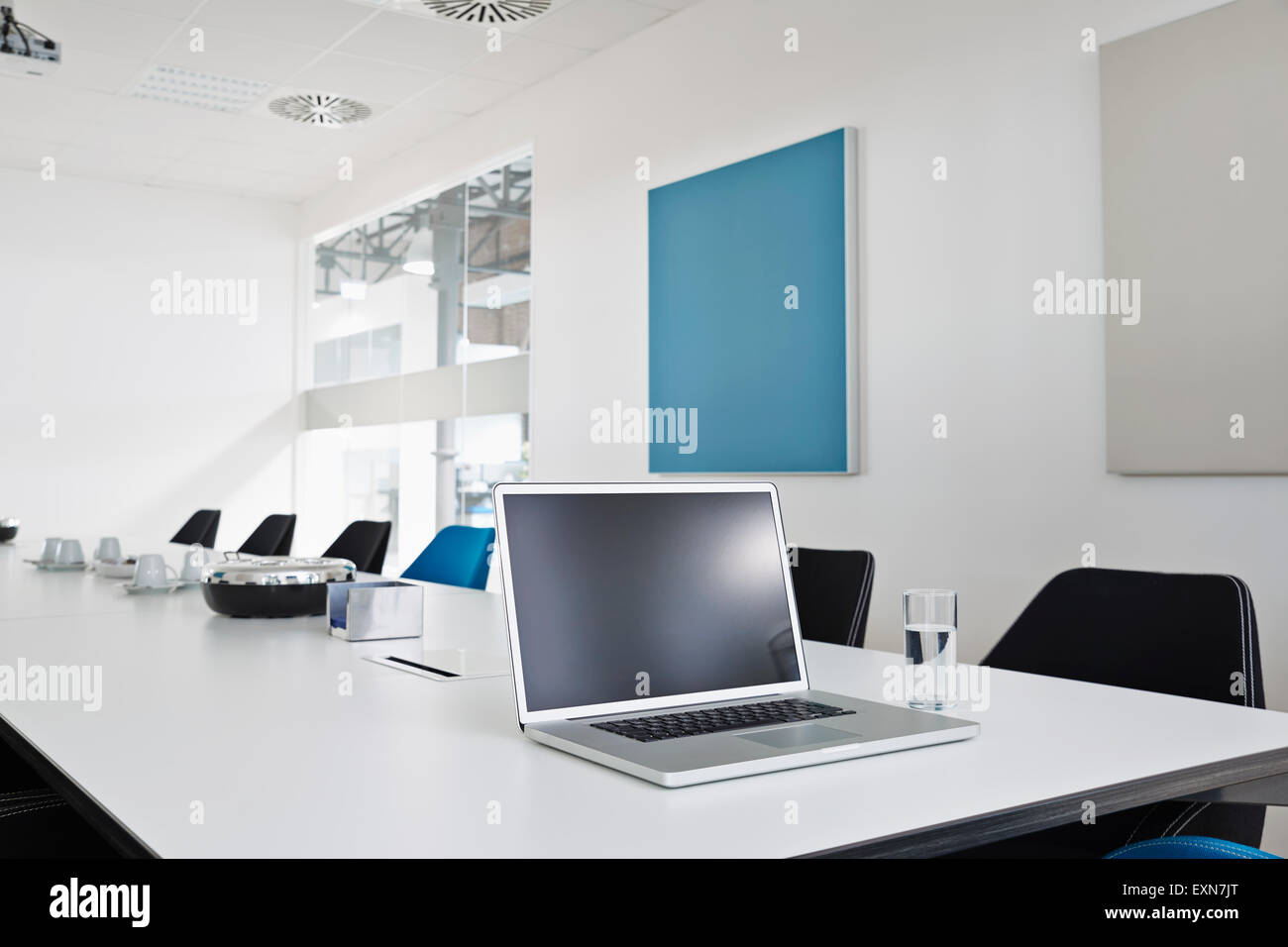 Laptop on conference table Stock Photo - Alamy