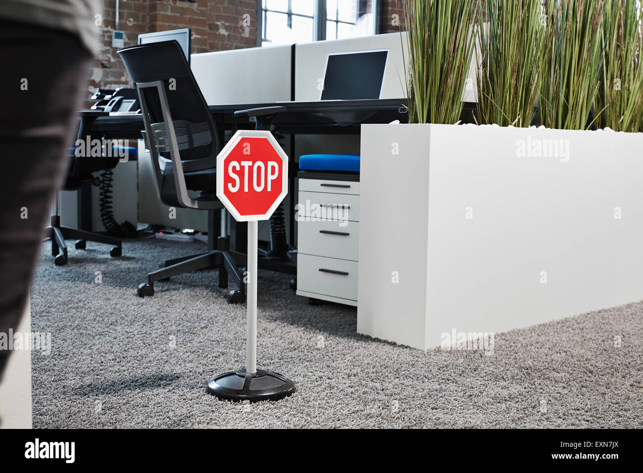 Stop sign in modern open plan office Stock Photo - Alamy