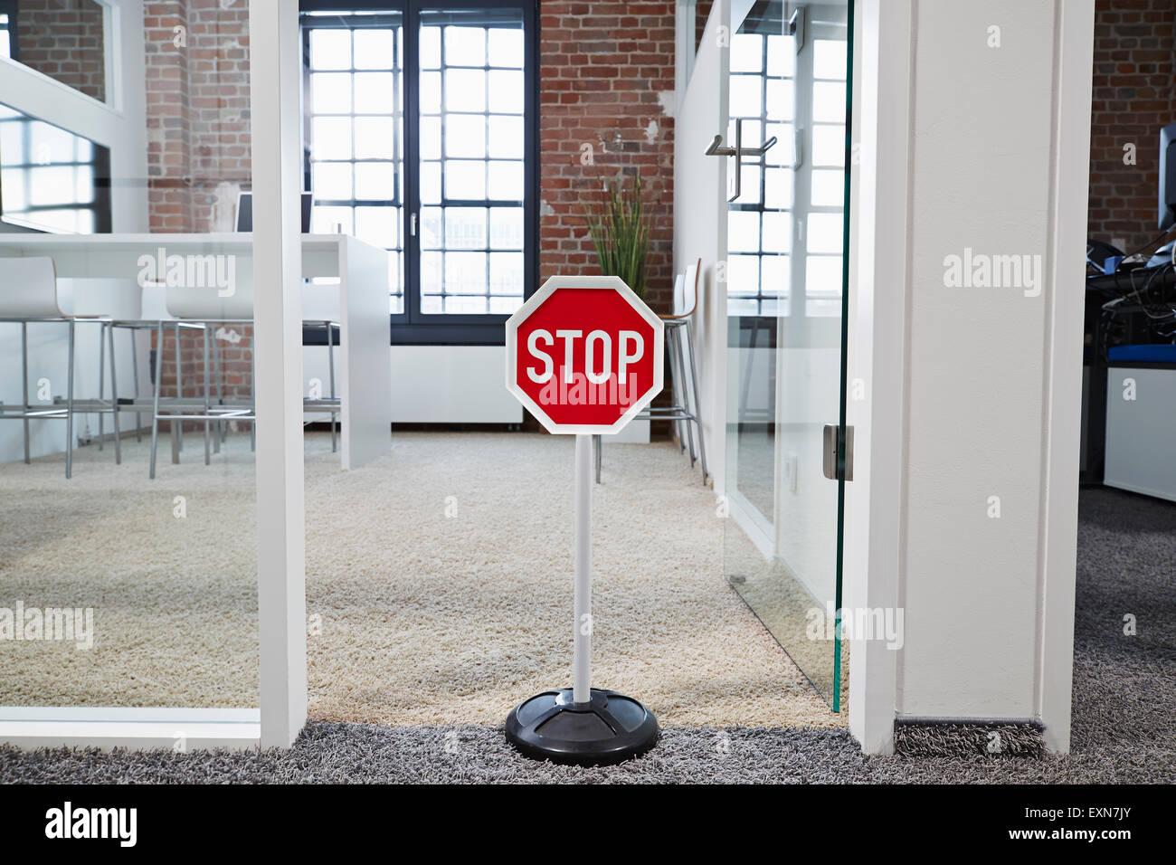 Stop sign in modern open plan office Stock Photo - Alamy