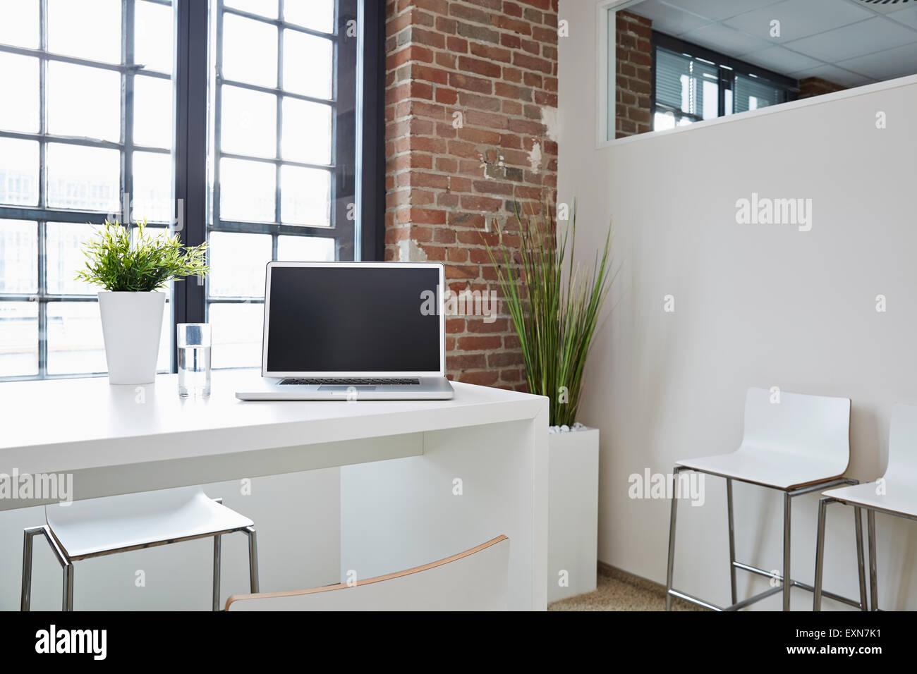 Laptop on desk in modern office Stock Photo - Alamy