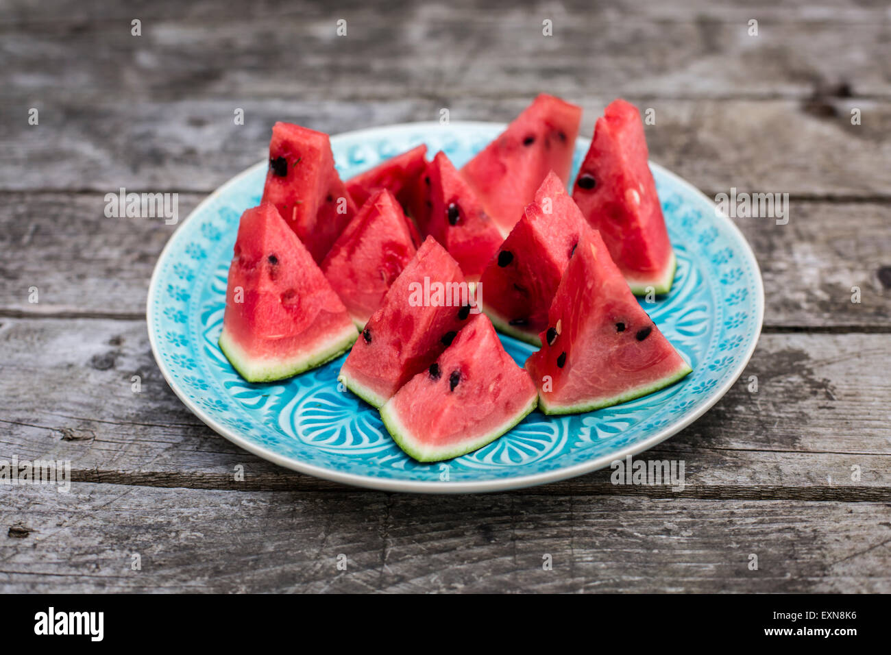 Chopped watermelon on blue plate Stock Photo - Alamy