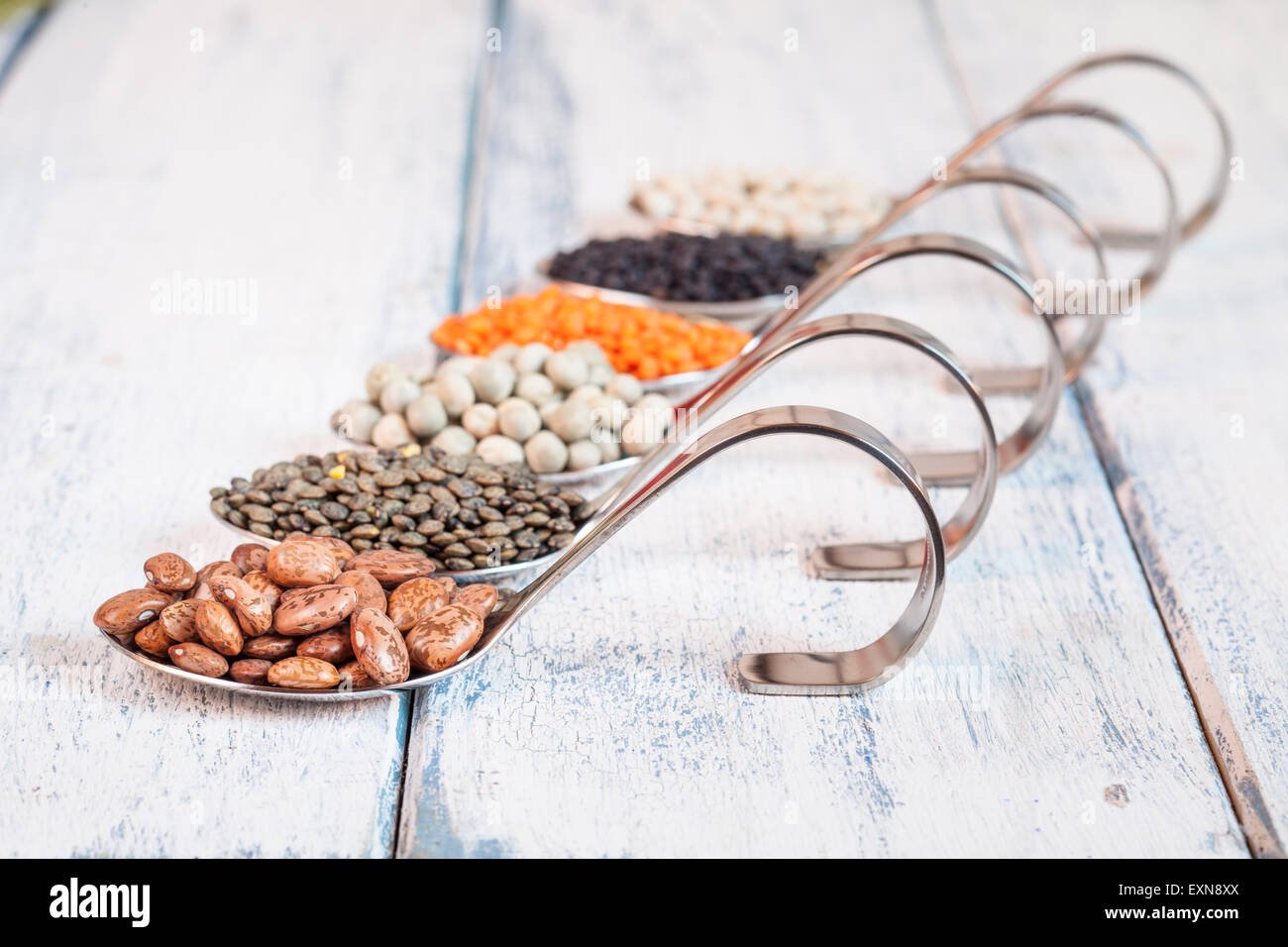 Row of spoons with different dried pulses Stock Photo - Alamy