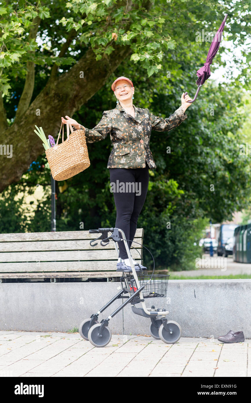Happy senior woman with wheeled walker Stock Photo - Alamy