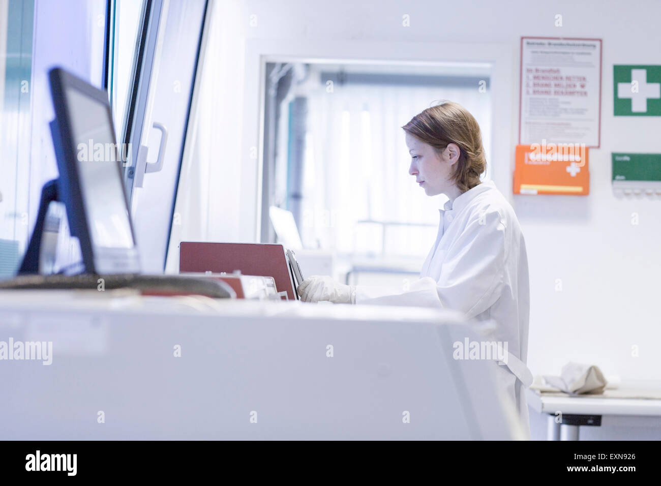 Laboratory assistant checking laboratory device Stock Photo - Alamy