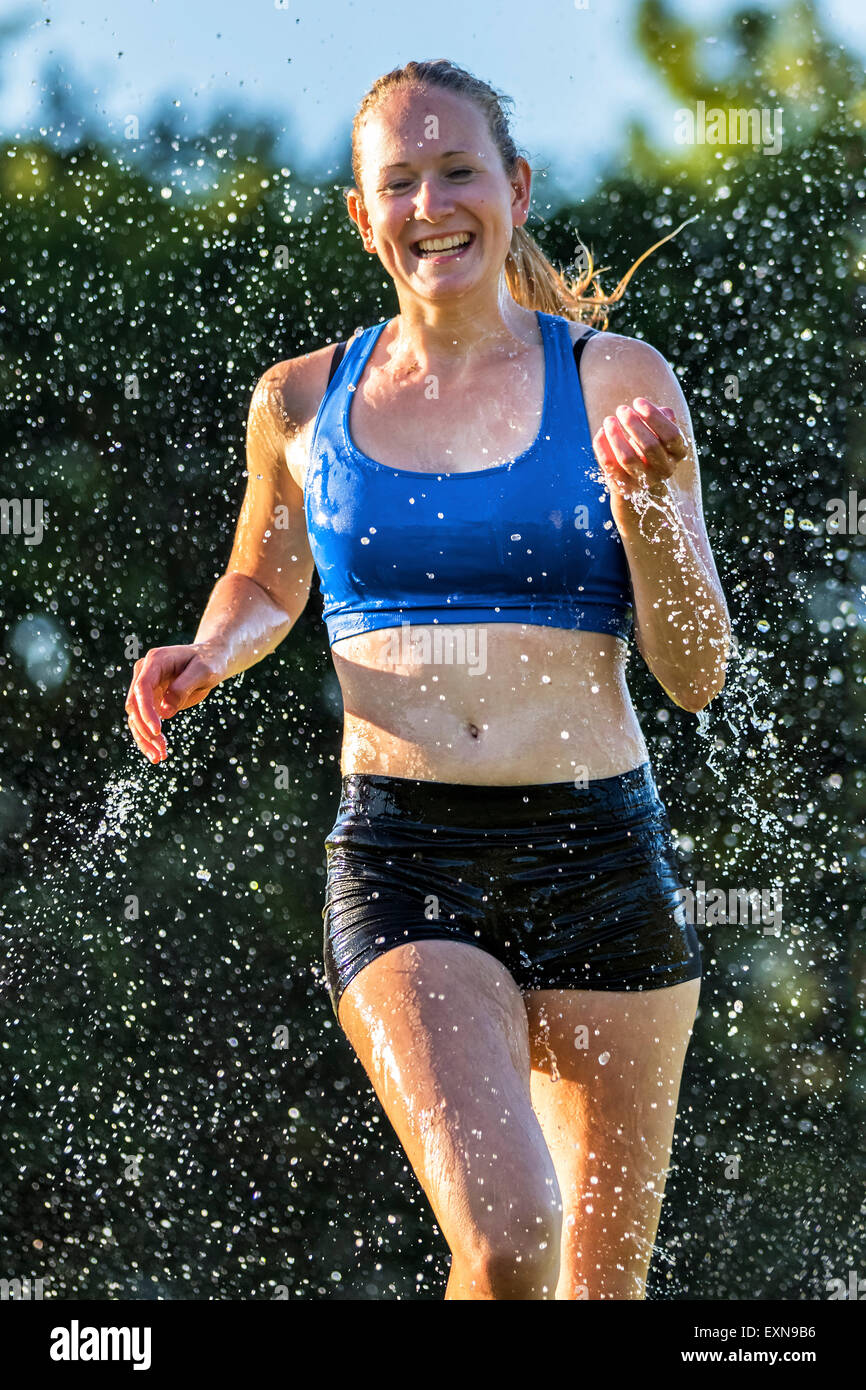 Young athlete running in rain Stock Photo - Alamy