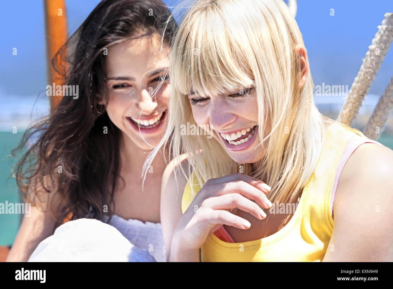 Two laughing young women on a sailing ship Stock Photo - Alamy