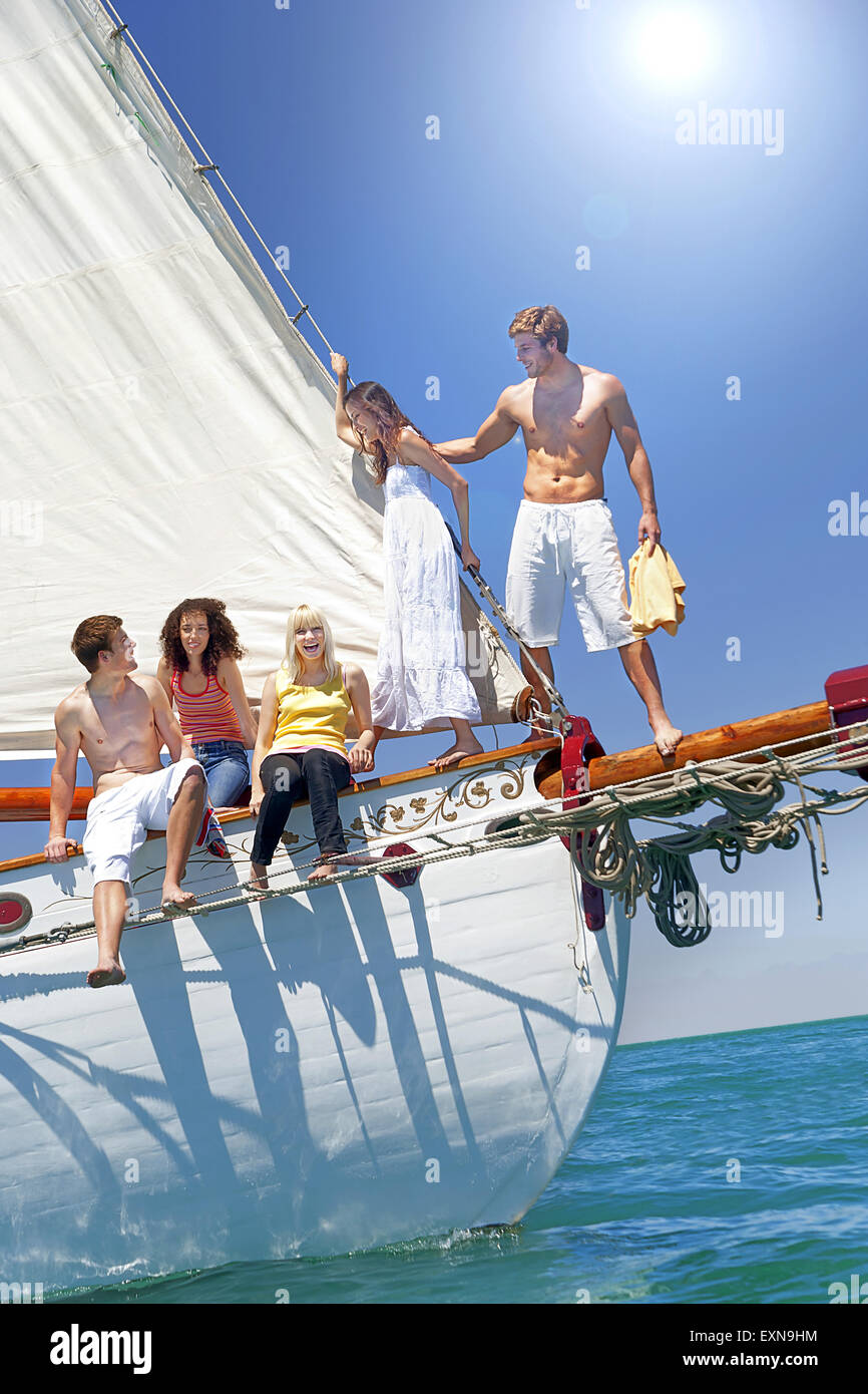 Happy friends on bow of a sailing ship Stock Photo - Alamy