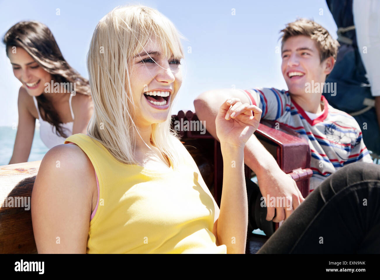 Happy friends on a sailing ship Stock Photo - Alamy