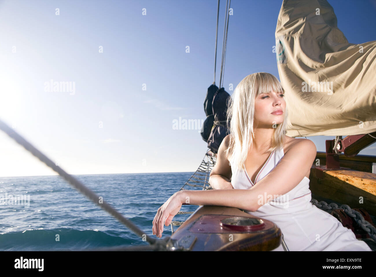 Blond young woman on a sailing ship Stock Photo - Alamy