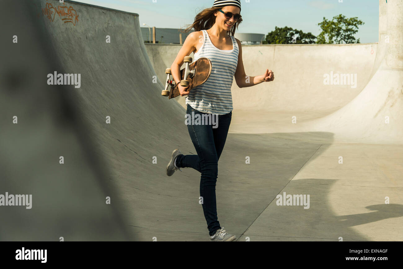 Young skate boarder running in a skatepark Stock Photo - Alamy