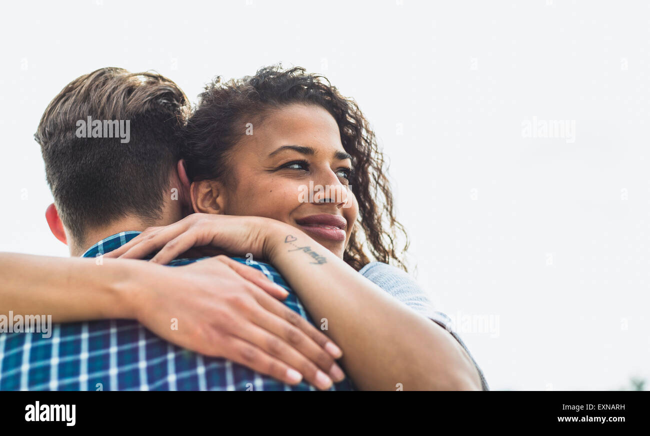 Young woman hugging boyfriend outdoors Stock Photo - Alamy