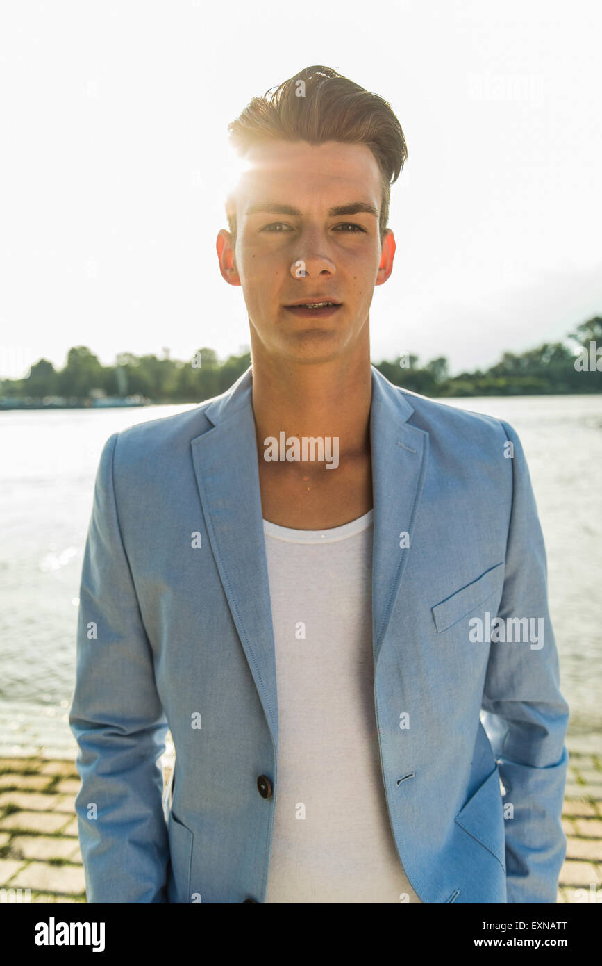 Portrait of young man wearing jacket by the riverside Stock Photo - Alamy