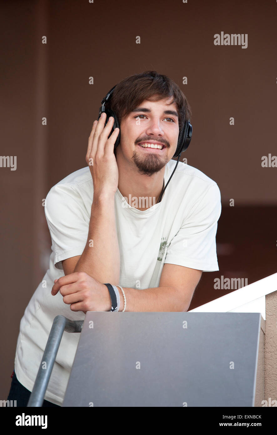 Portrait of young man hearing music with headphones Stock Photo - Alamy