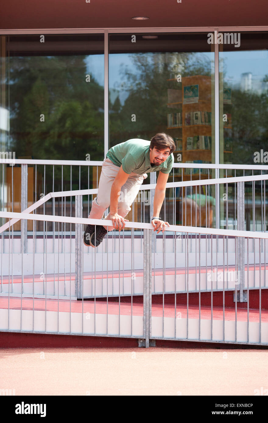 Young man jumping over railing hi-res stock photography and images - Alamy