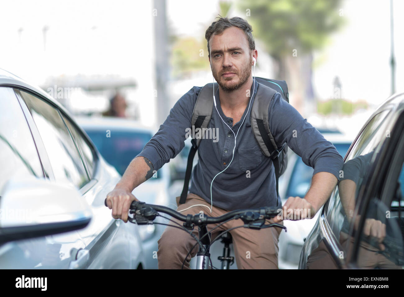 Man on bicycle in traffic jam Stock Photo - Alamy