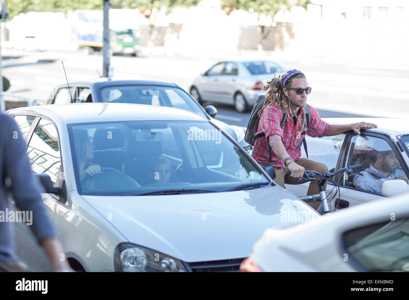 Young man on bicycle in traffic jam Stock Photo - Alamy
