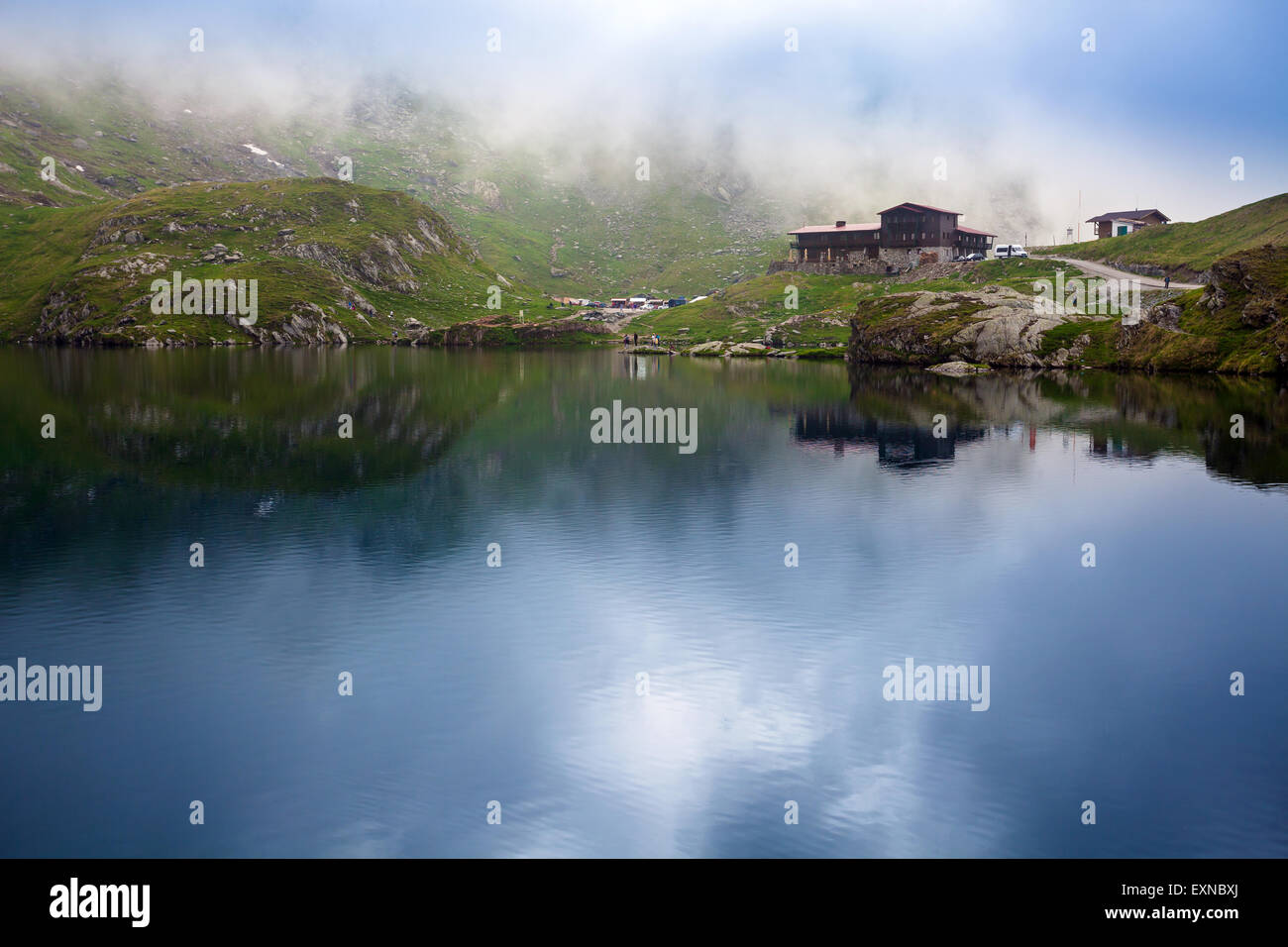 BALEA LAKE, ROMANIA - JUNE 24, 2012: Idyllic view with typical lodge on ...
