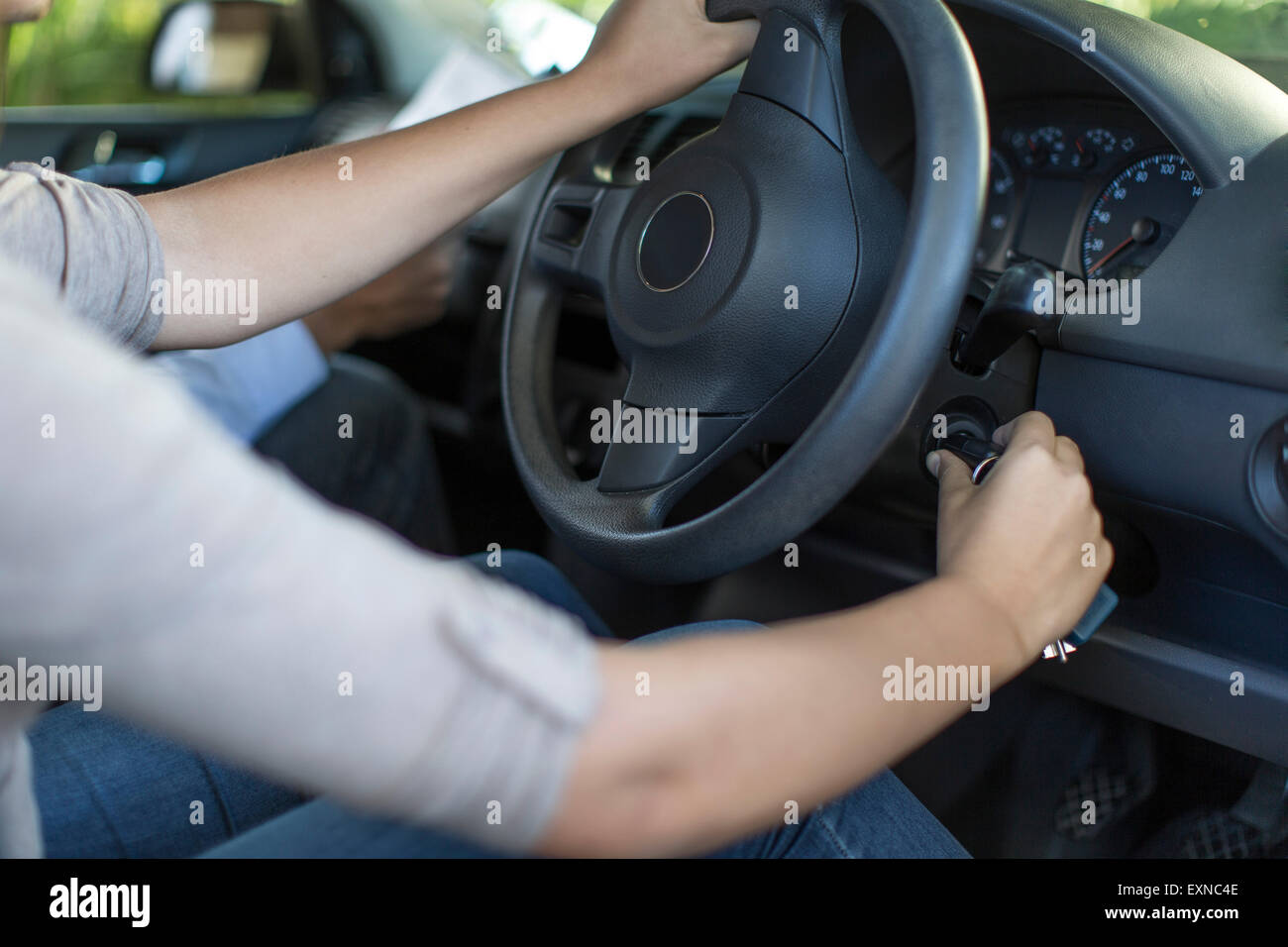 Teenage girl starting a car Stock Photo - Alamy