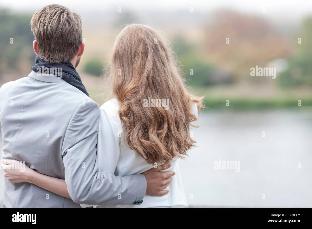 Back view of a couple arm in arm Stock Photo - Alamy