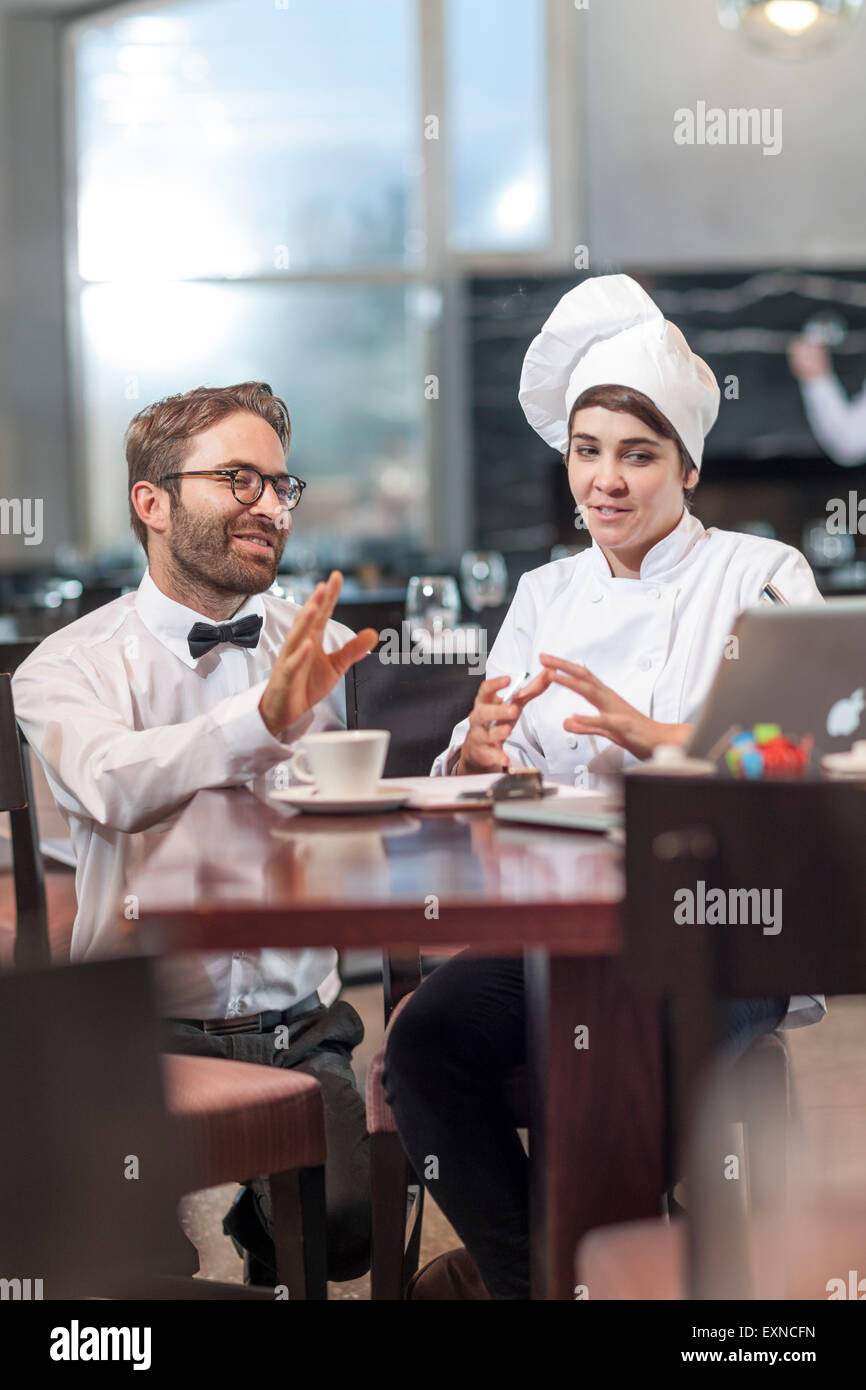 Restaurant chef and manager discussing menu Stock Photo - Alamy