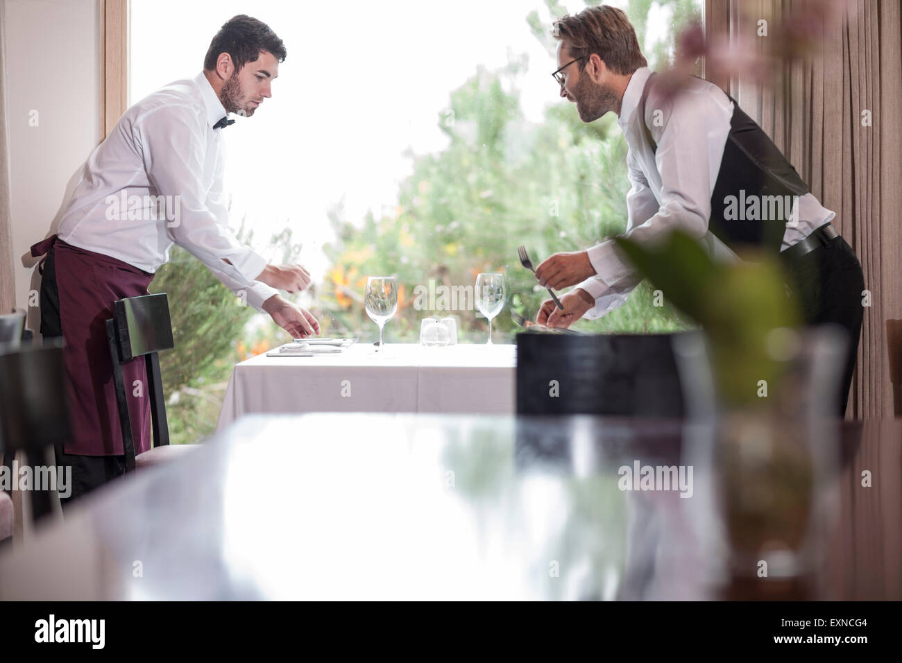 Restaurant staff setting tables Stock Photo - Alamy