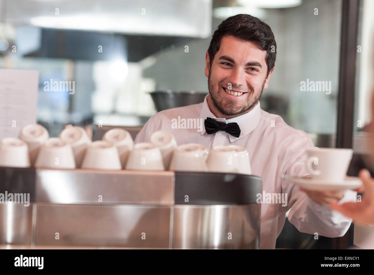 Barista serving coffee Stock Photo - Alamy