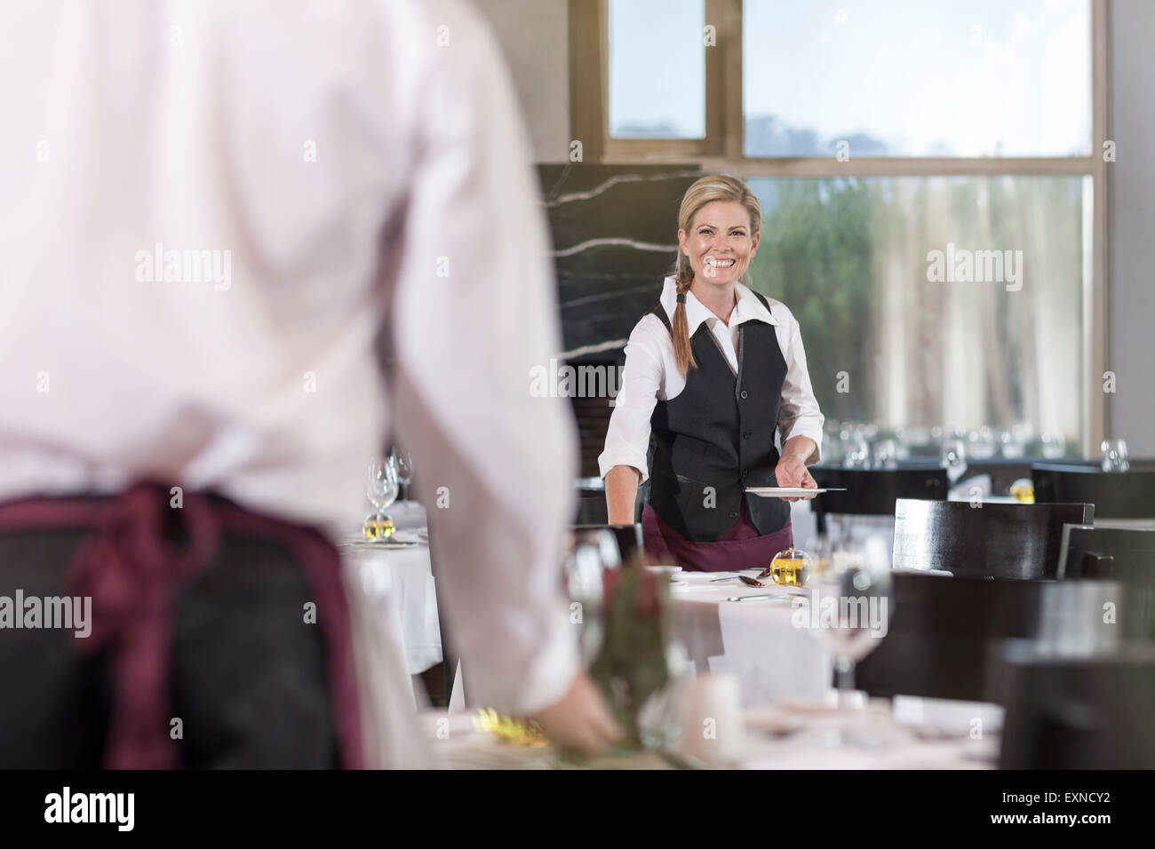 Restaurant staff setting tables Stock Photo - Alamy