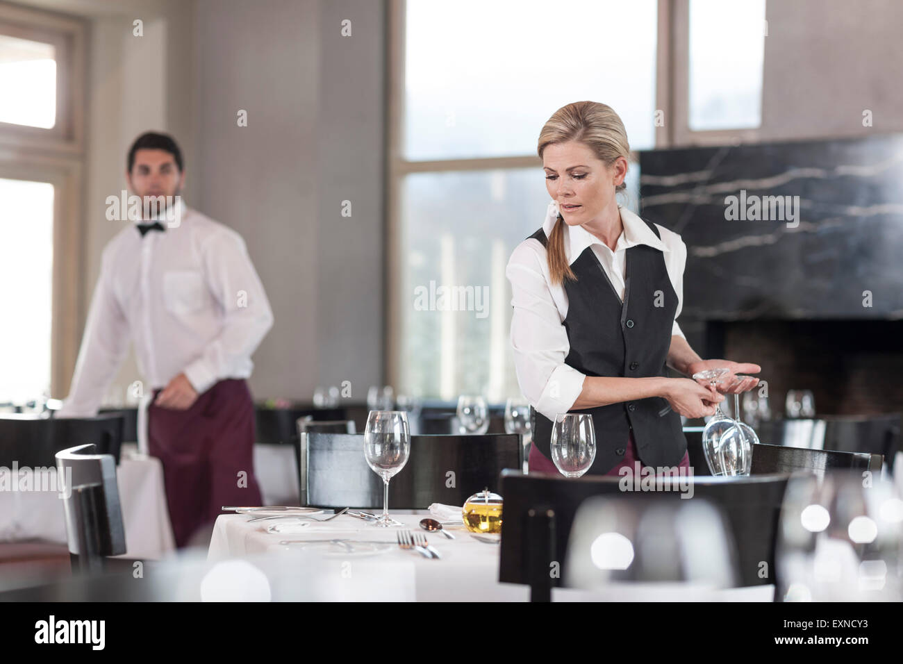 Restaurant staff setting tables Stock Photo - Alamy