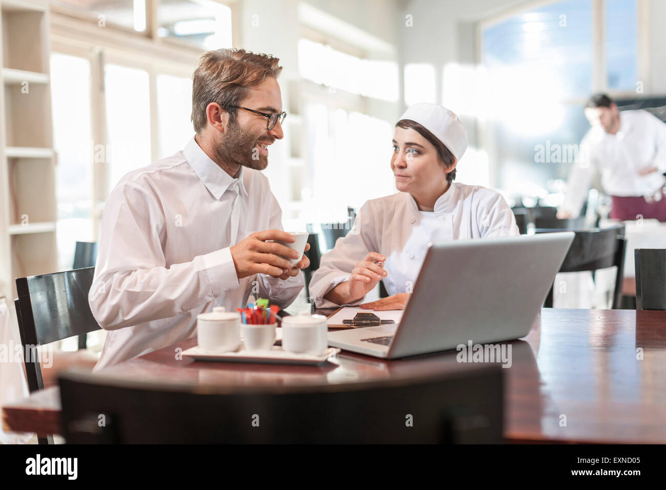 Restaurant chef and manager discussing menu Stock Photo - Alamy