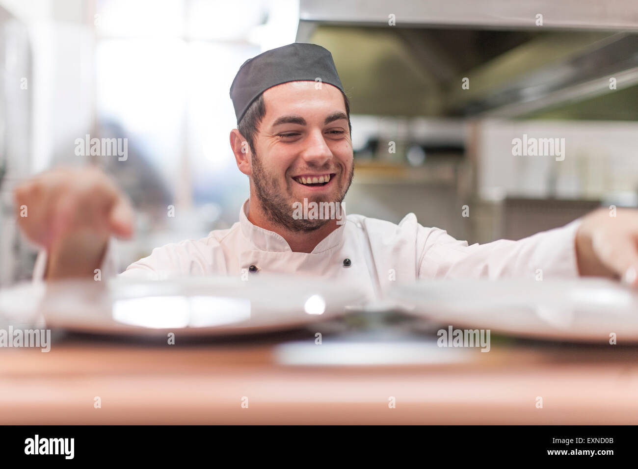 Chef preparing plates in restaurant kitchen Stock Photo - Alamy