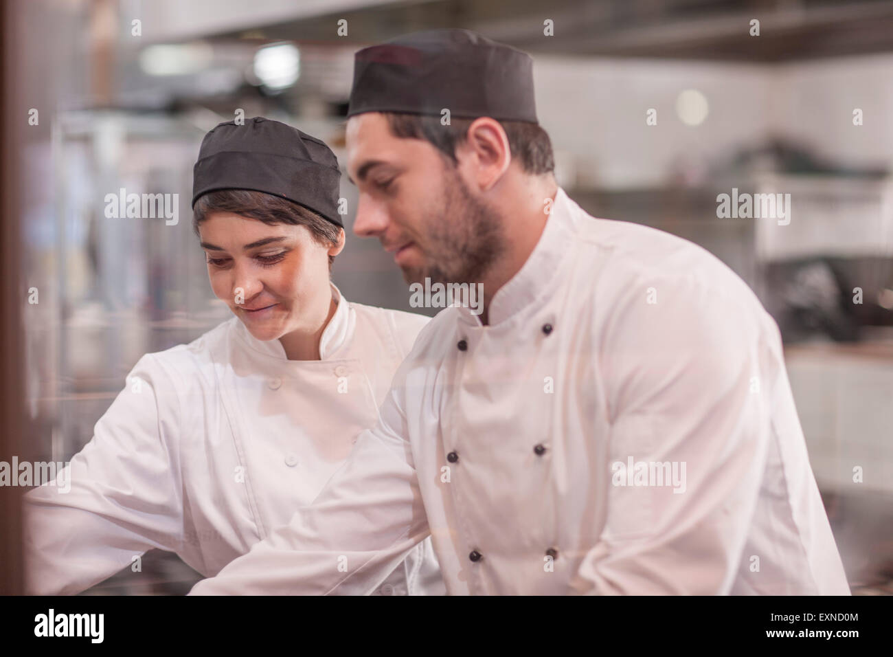 Two chefs working together in kitchen Stock Photo - Alamy