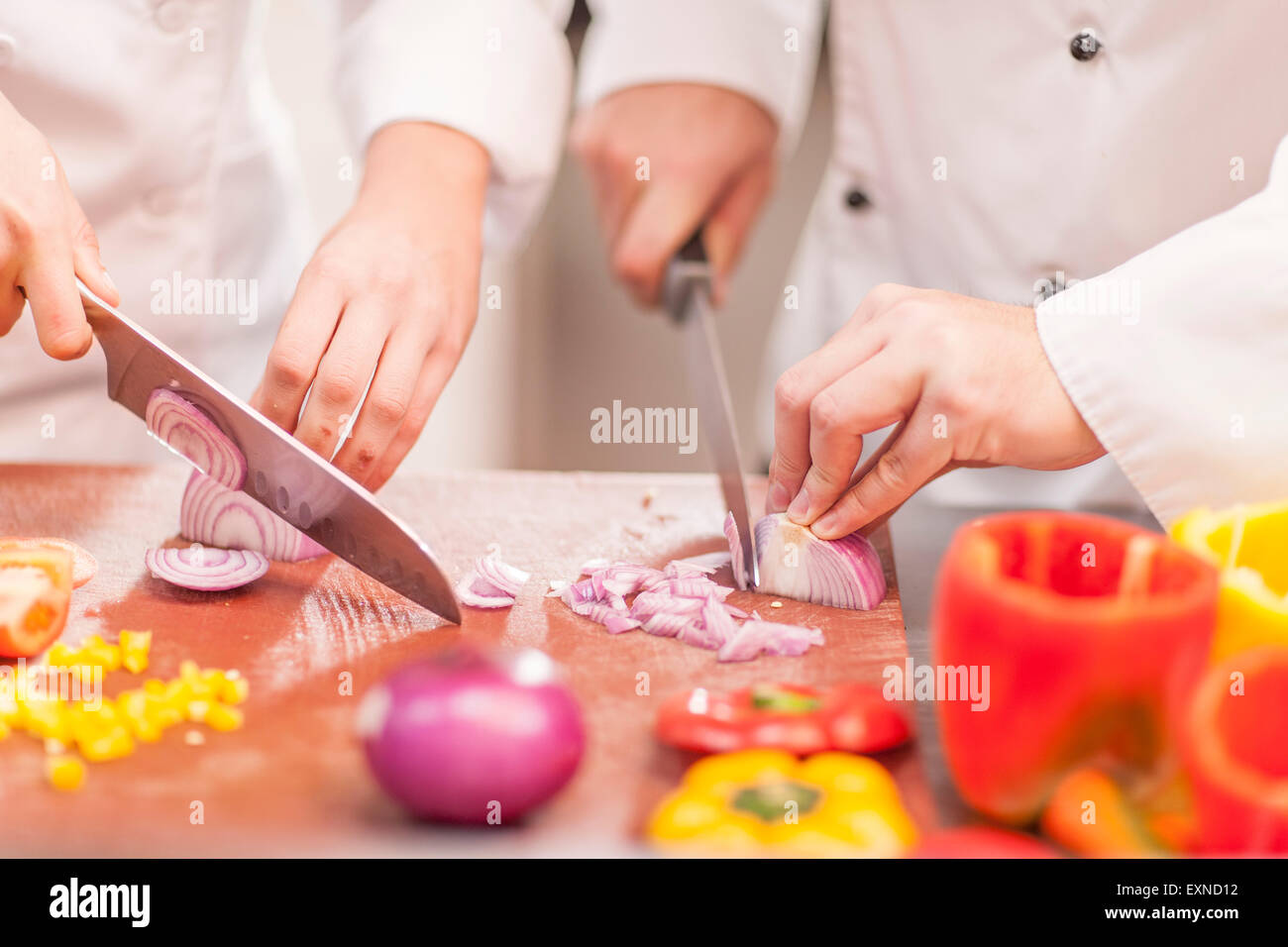 Two chefs chopping vegetables Stock Photo - Alamy